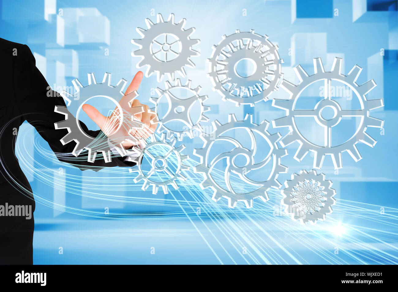 Digital composite of finger pointing to cogs and wheels Stock Photo - Alamy