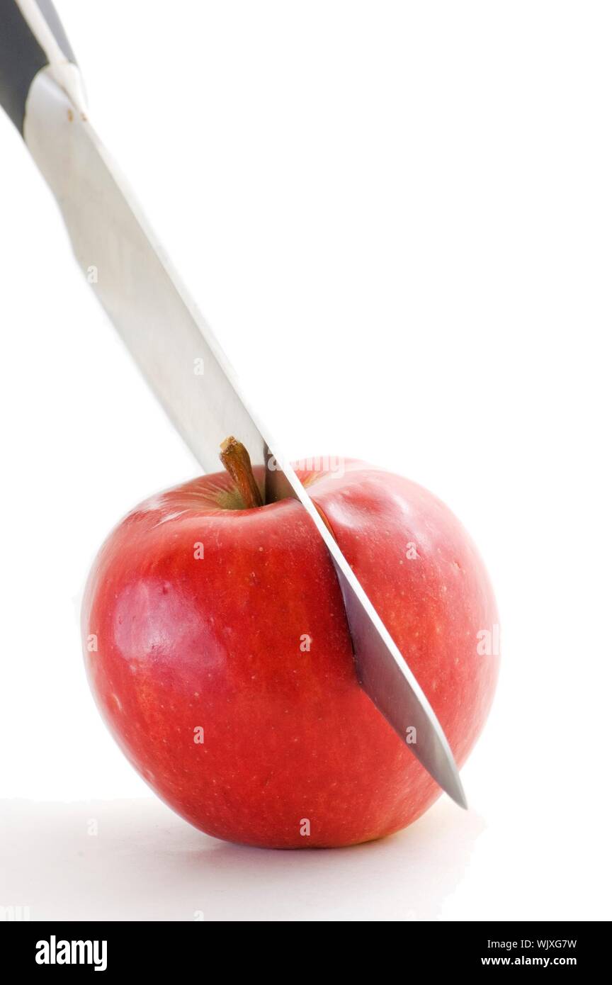 Long bladed kitchen knife cutting through a red apple Stock Photo - Alamy