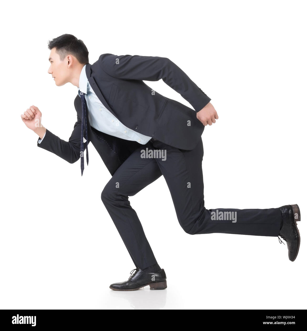 Attractive young business man running, full length portrait isolated on ...