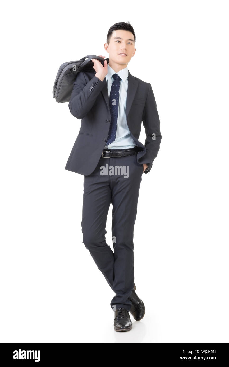 Confident young business man with briefcase, full length portrait ...