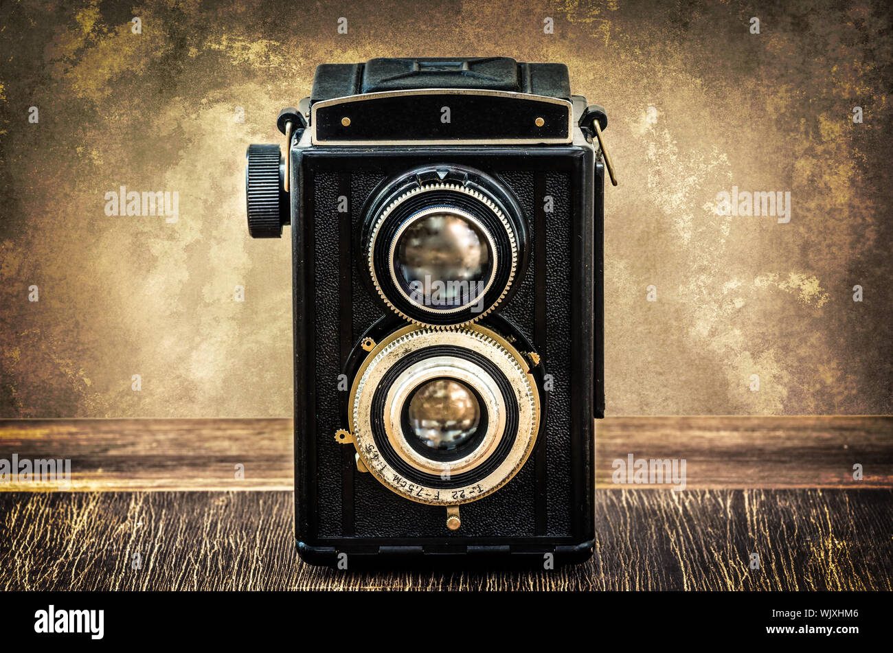 Old fashioned antique camera in vintage style with filtered textured ...