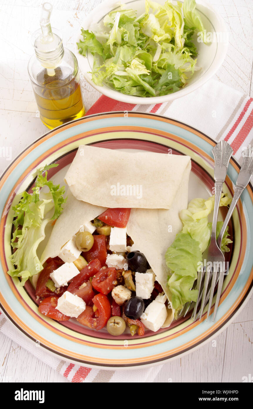 mediterranean style crepe with tomato, salad, goat cheese, green and ...