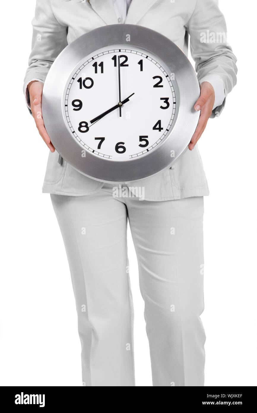 Beautiful woman standing over a white background holding a clock Stock ...