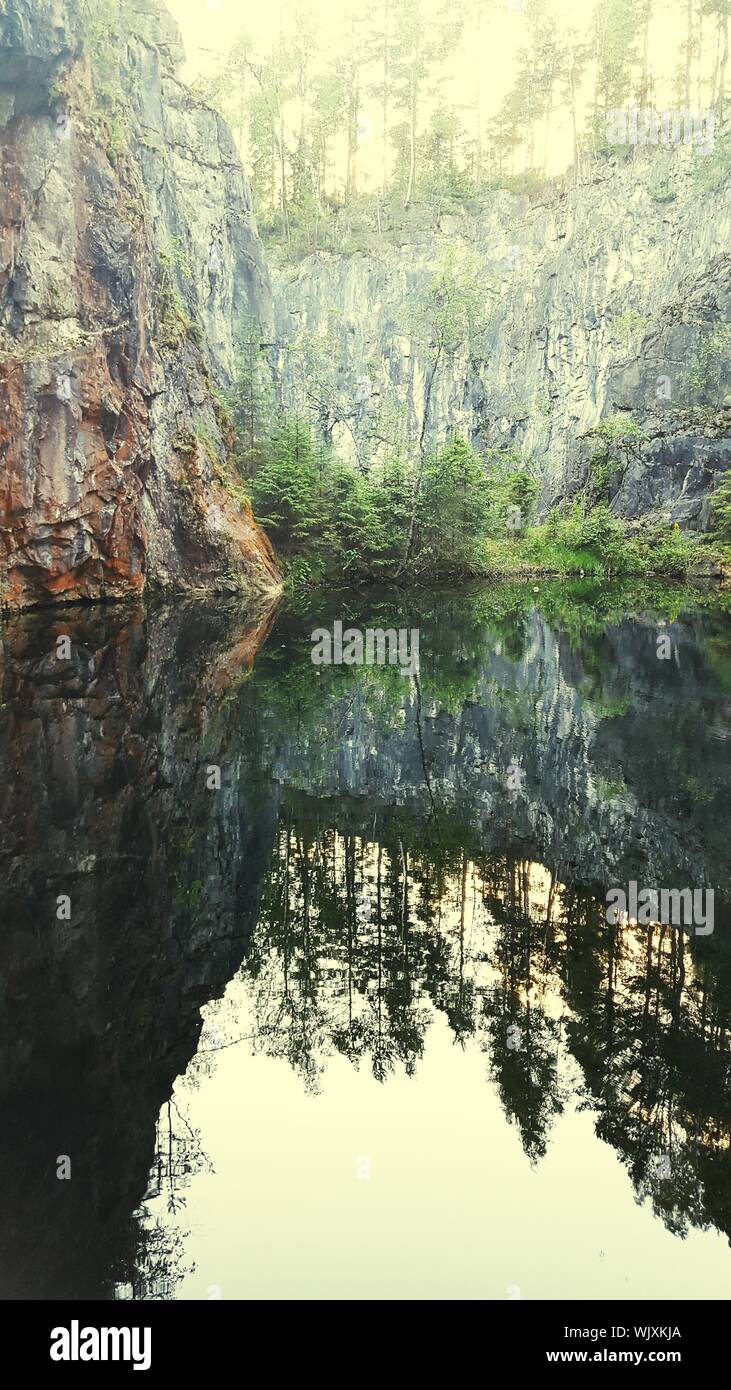 Lake By Limestone Rock Cliff With Reflection Stock Photo - Alamy