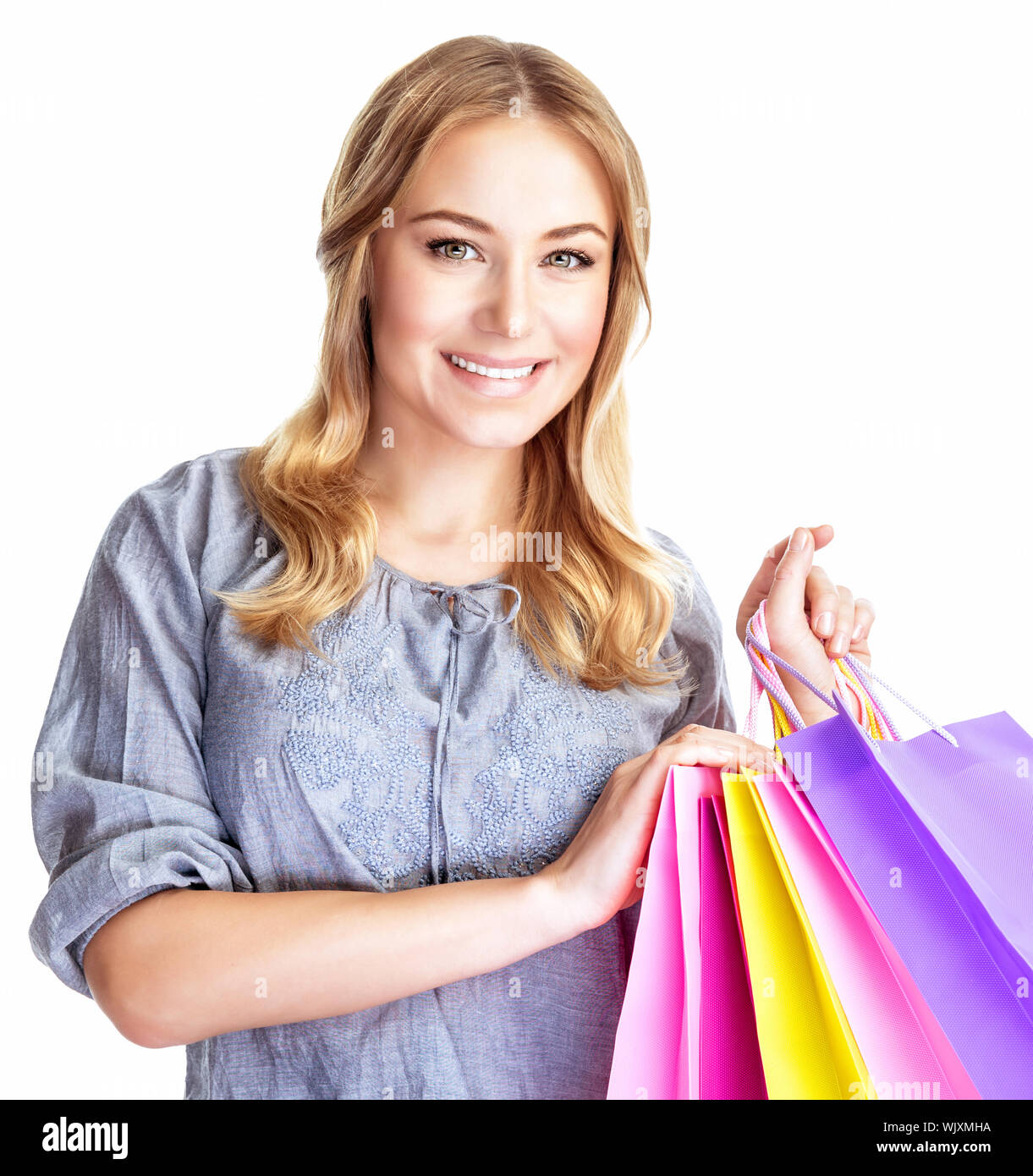 Closeup portrait of happy shopper girl with four colourful paper bags ...
