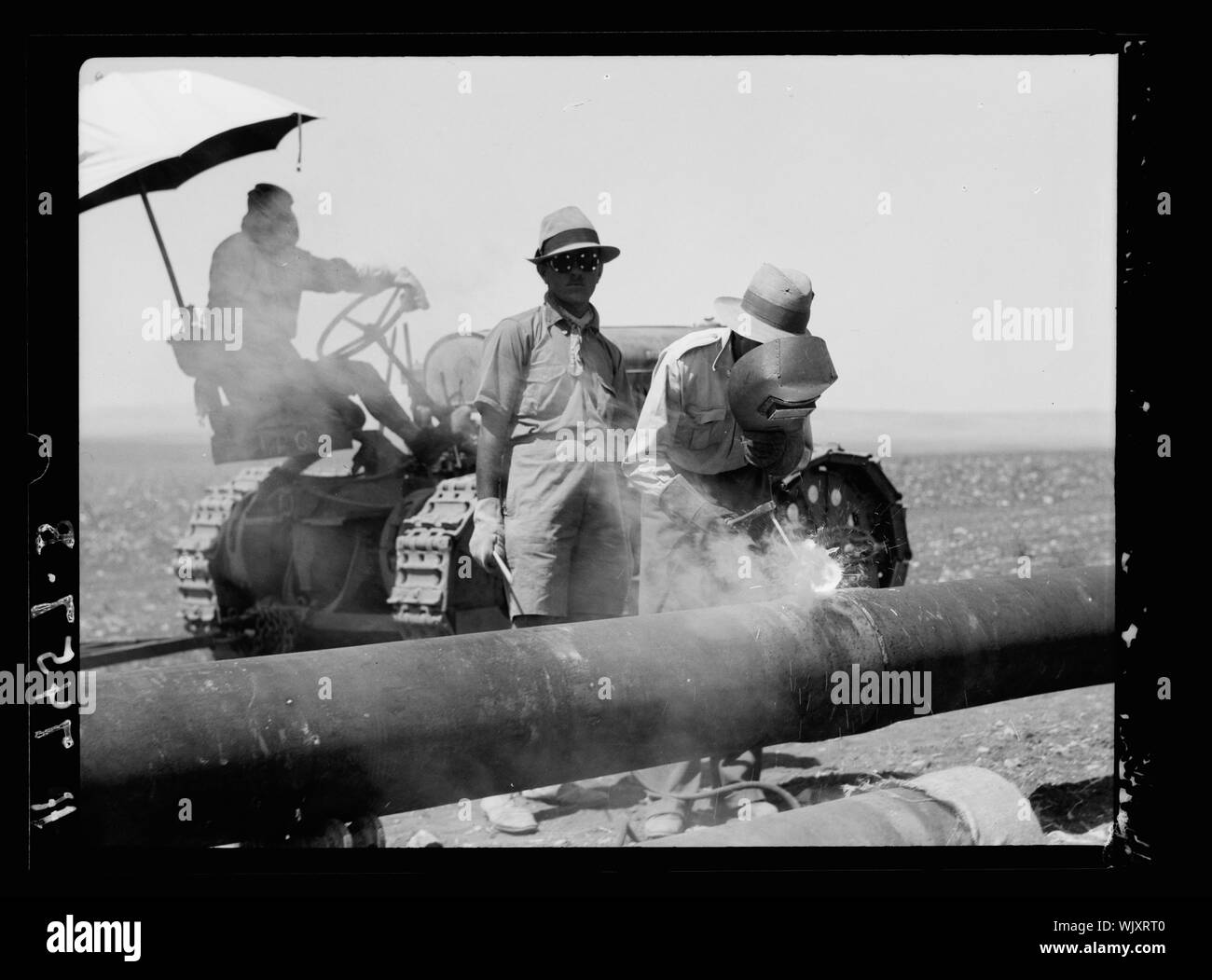 I.P.C. i.e., Iraq Petroleum Company. Welding pipes together, on ...