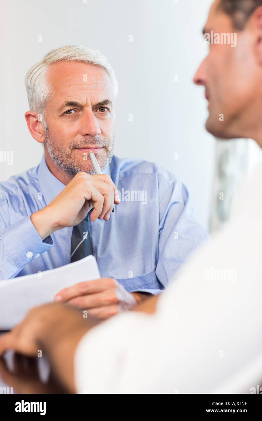 Businessmen doing paperwork together in hi-res stock photography and ...