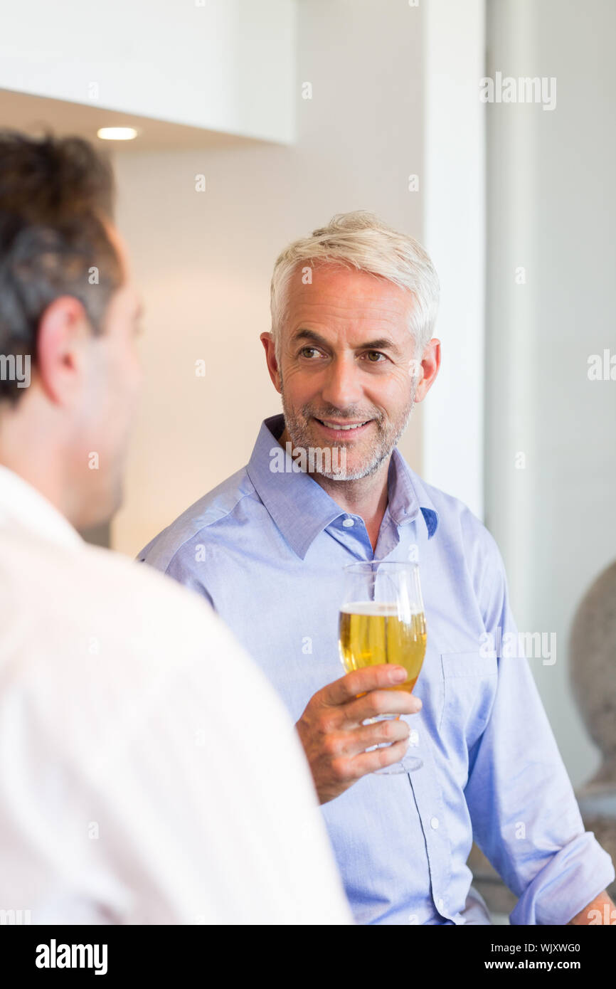 Two business colleagues drinking beer at the bar counter Stock Photo ...