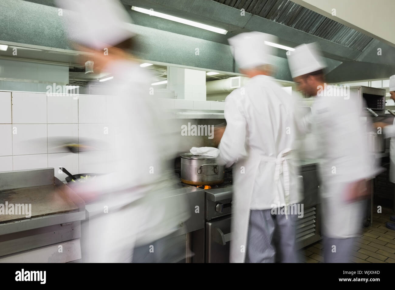 Chefs in commercial kitchen blurred hi-res stock photography and images ...