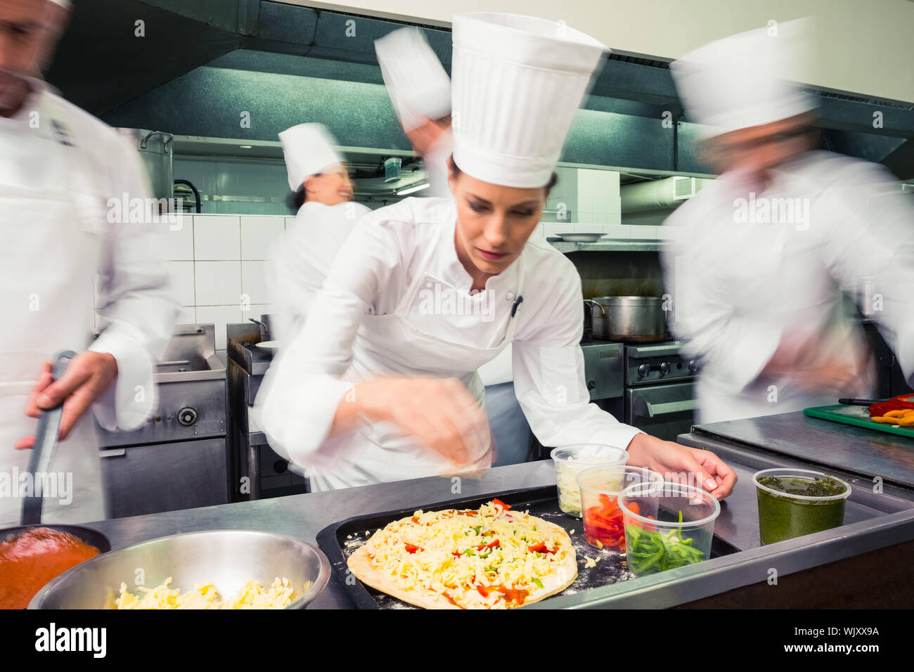 Focused chef preparing a pizza in a commercial kitchen Stock Photo - Alamy