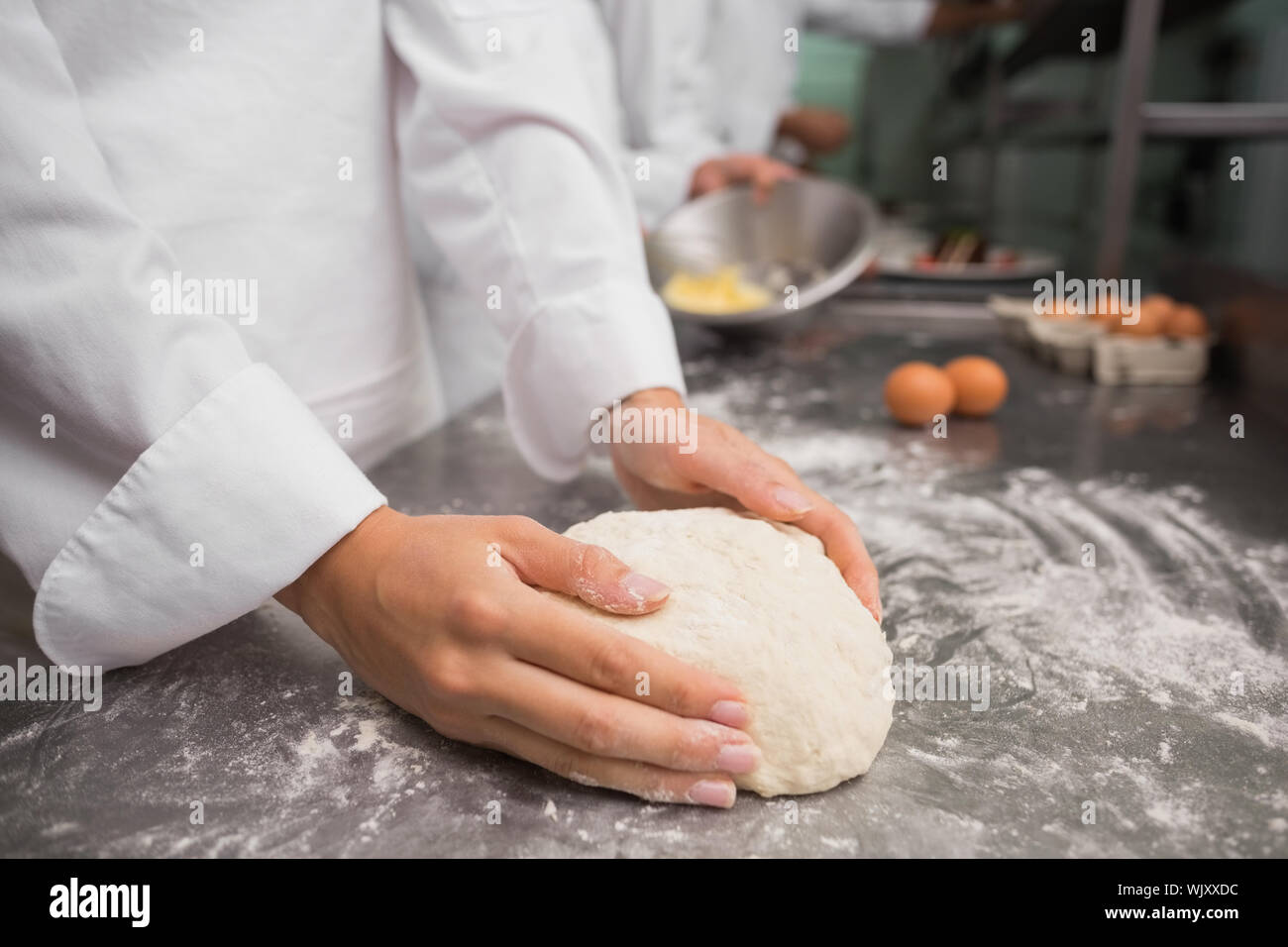 Chef preparing dough at counter in a commercial kitchen Stock Photo - Alamy