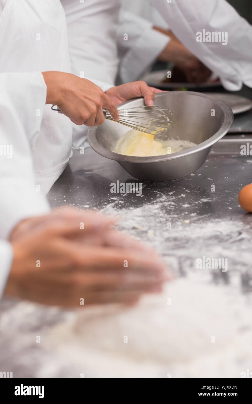 Chef preparing pastry at counter in a commercial kitchen Stock Photo ...