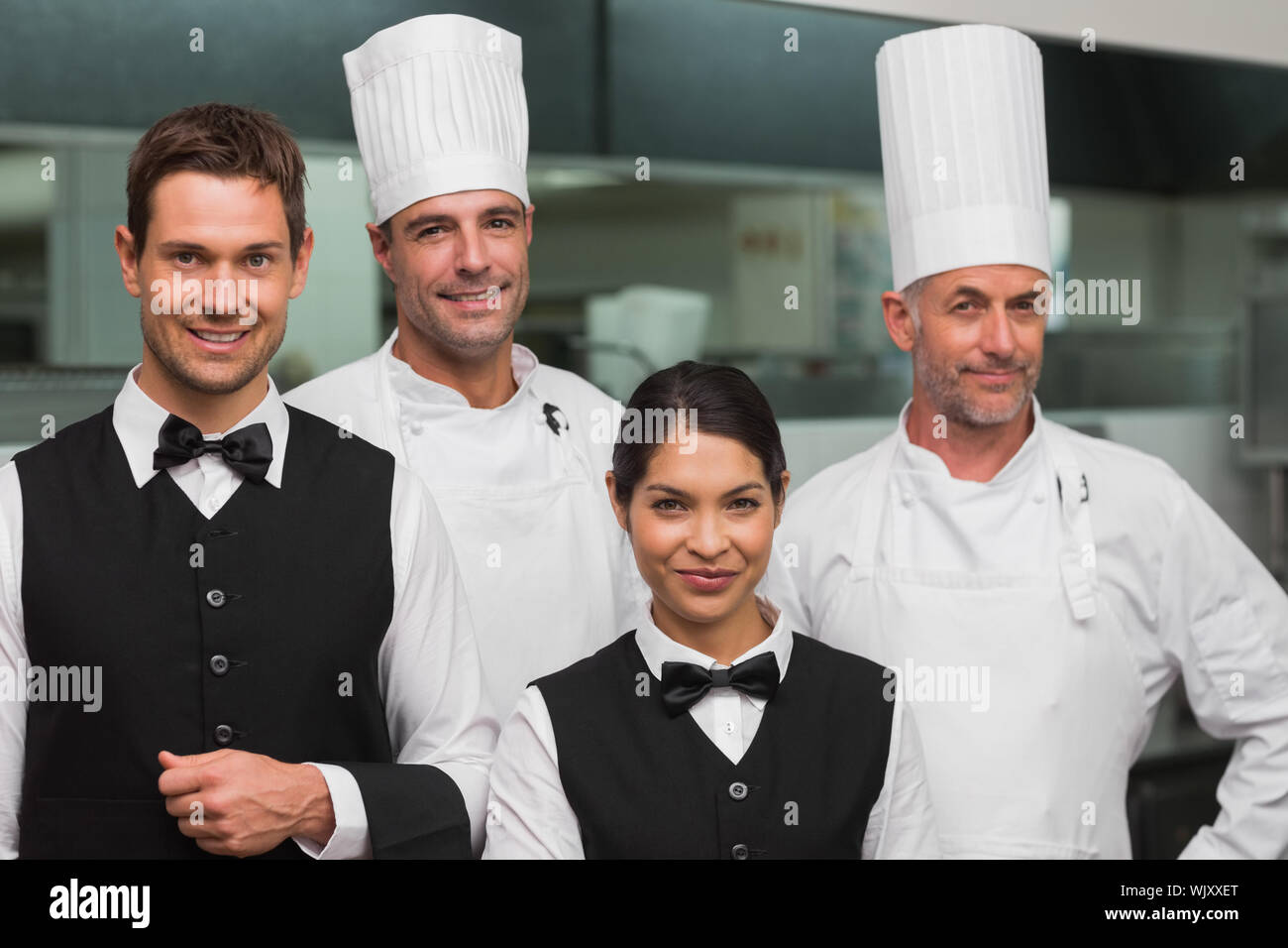 Restaurant team posing together smiling at camera in a commercial ...