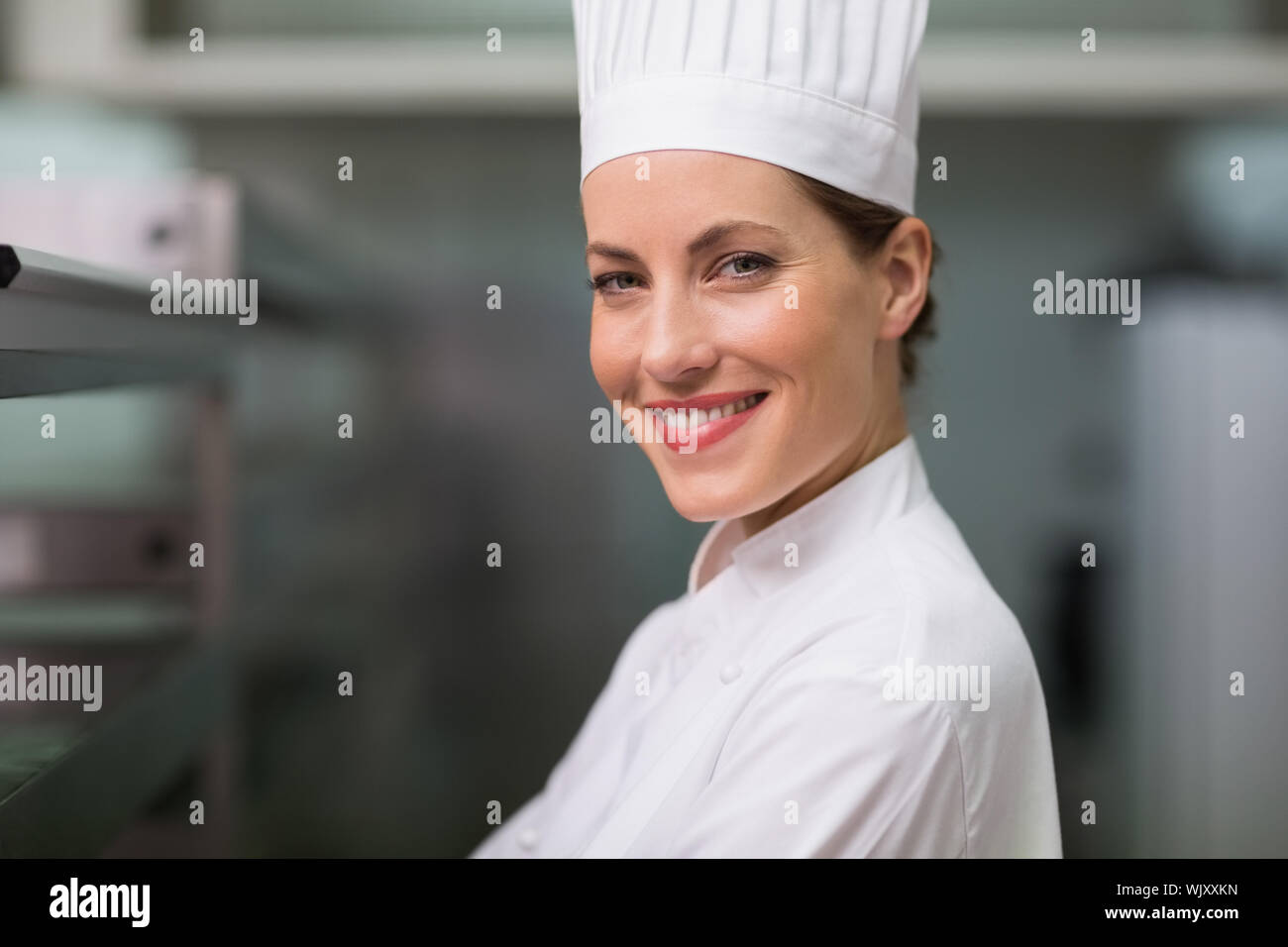 Happy chef smiling at camera in a commercial kitchen Stock Photo - Alamy