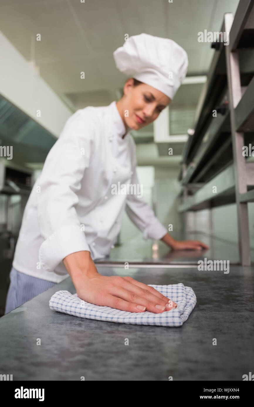 Chef wiping down surface in a commercial kitchen Stock Photo - Alamy