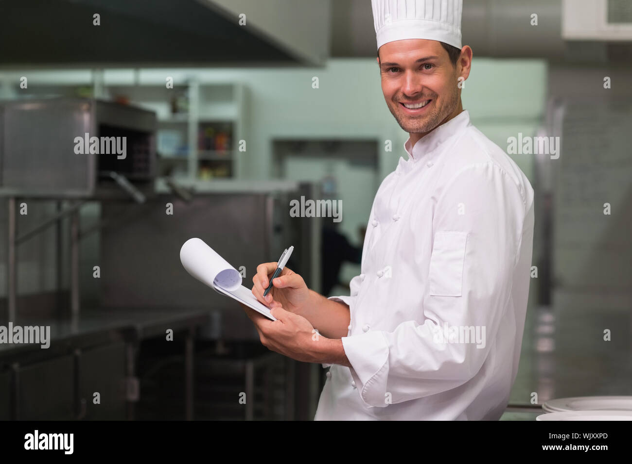 Head chef planning the menu in a commercial kitchen Stock Photo - Alamy