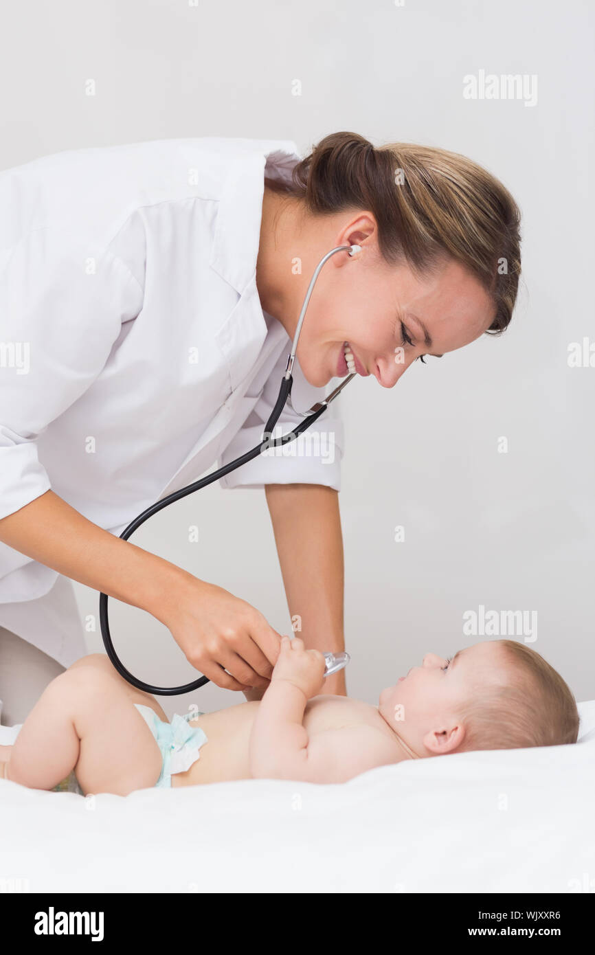 Beautiful doctor examining baby boy in hospital Stock Photo - Alamy