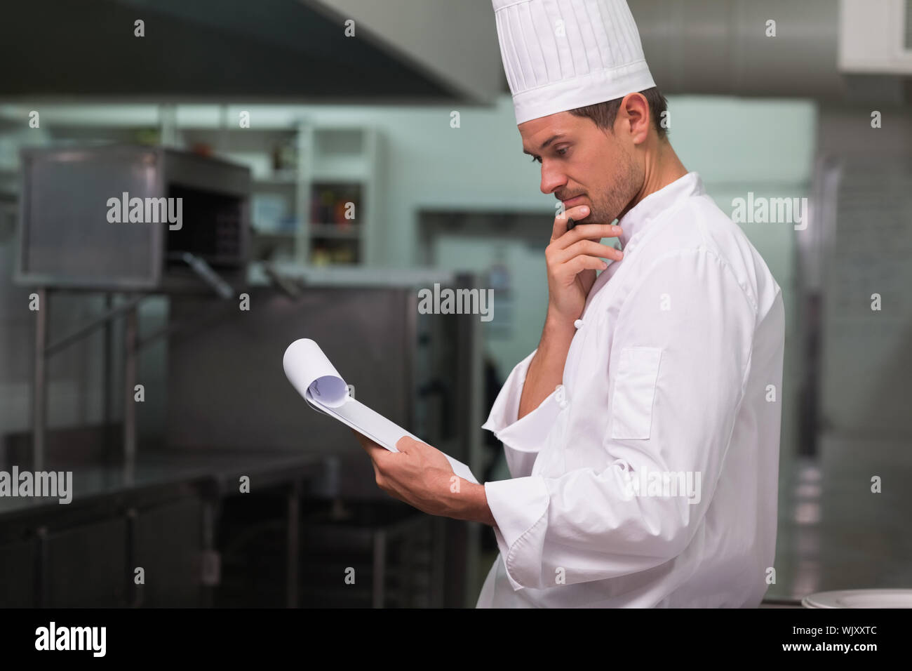 Head chef planning the menu in a commercial kitchen Stock Photo - Alamy