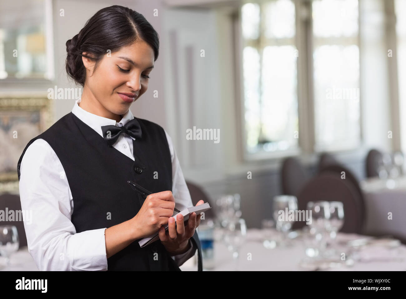 Pretty waitress taking an order in a fancy restaurant Stock Photo - Alamy