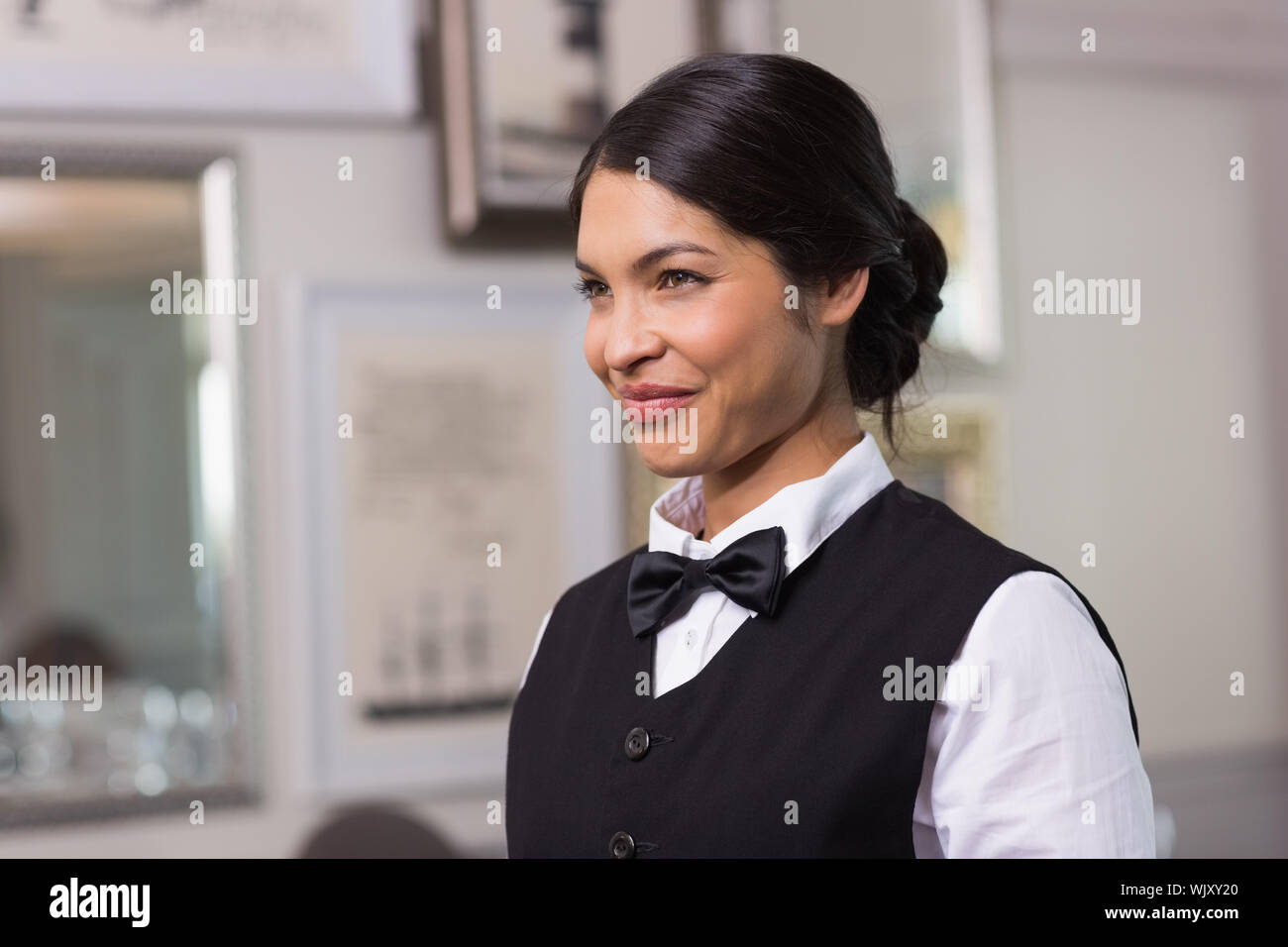 Pretty waitress smiling in a fancy restaurant Stock Photo - Alamy