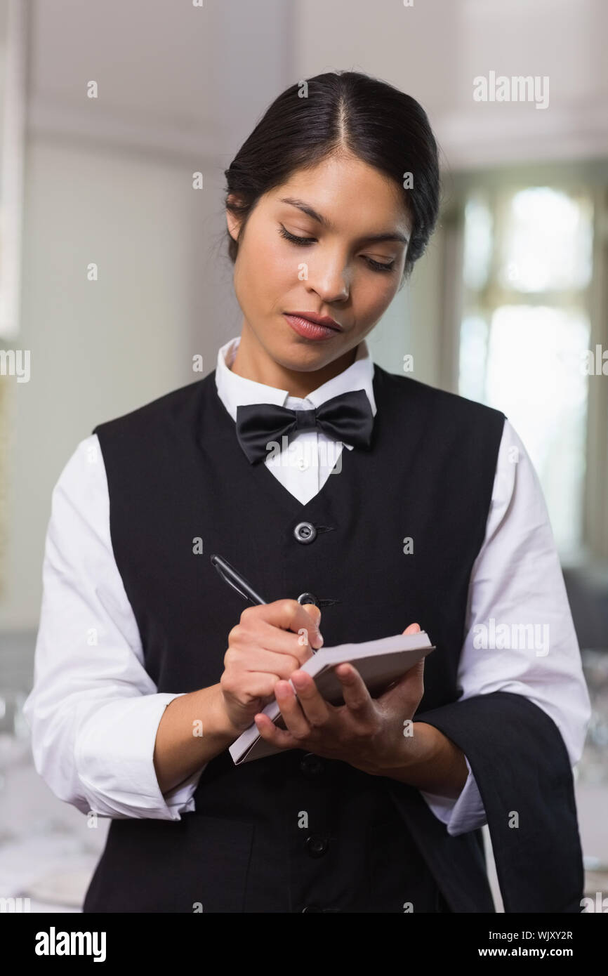 Pretty waitress taking an order in a fancy restaurant Stock Photo - Alamy