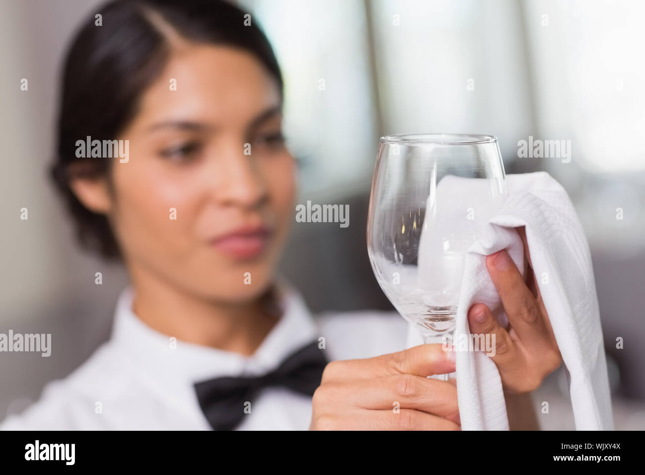 Pretty waitress polishing a wine glass in a fancy restaurant Stock ...