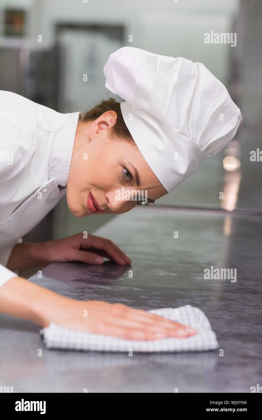 Chef wiping down surface in a commercial kitchen Stock Photo - Alamy