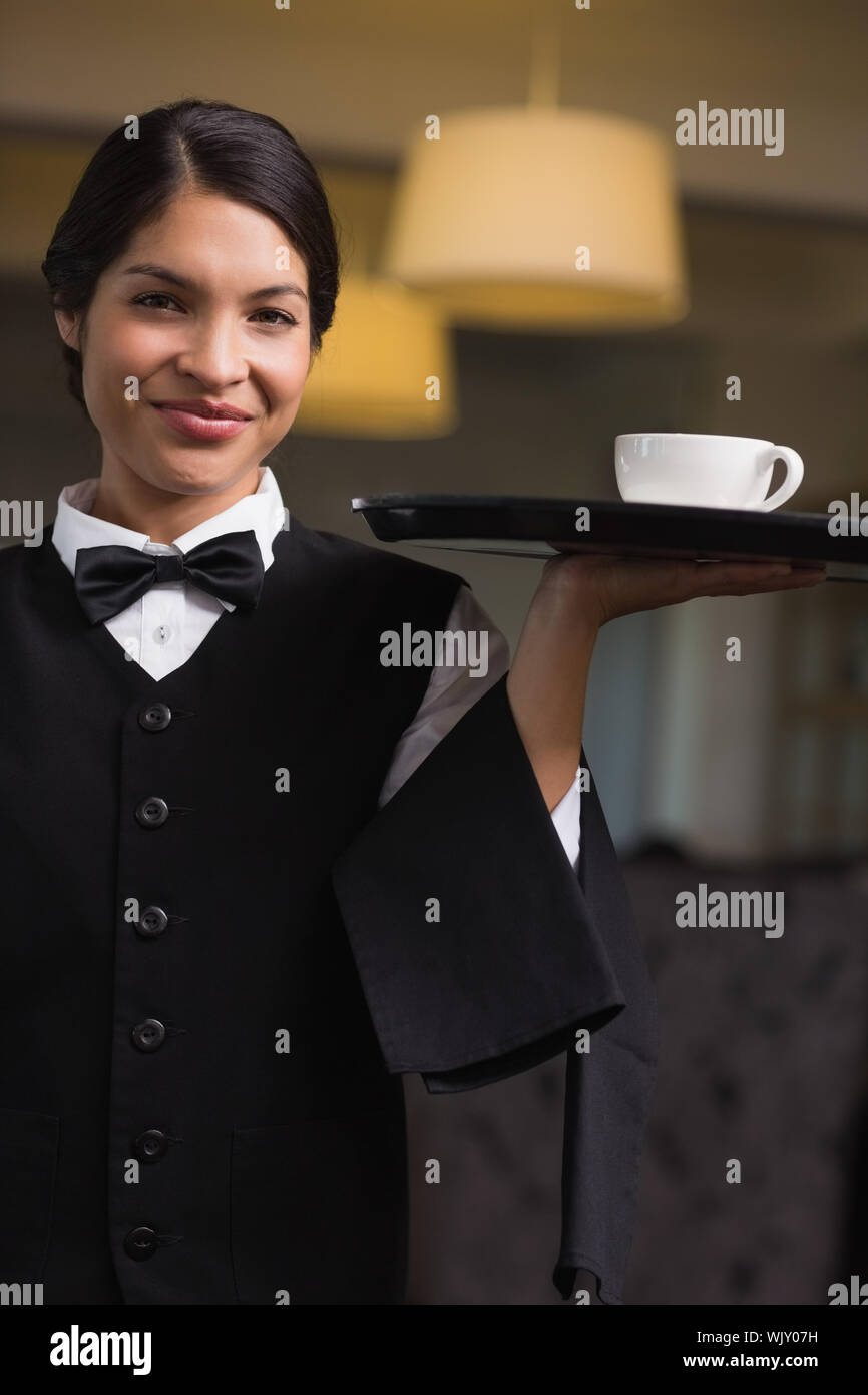 Pretty waitress holding a tray with a cup in a fancy restaurant Stock ...