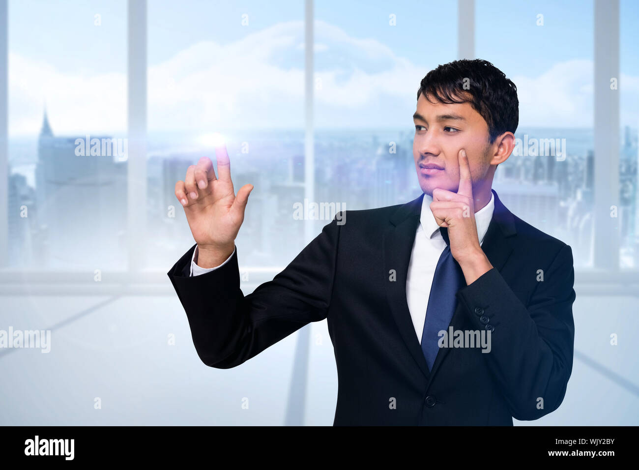 Digital composite of serious businessman touching light Stock Photo - Alamy