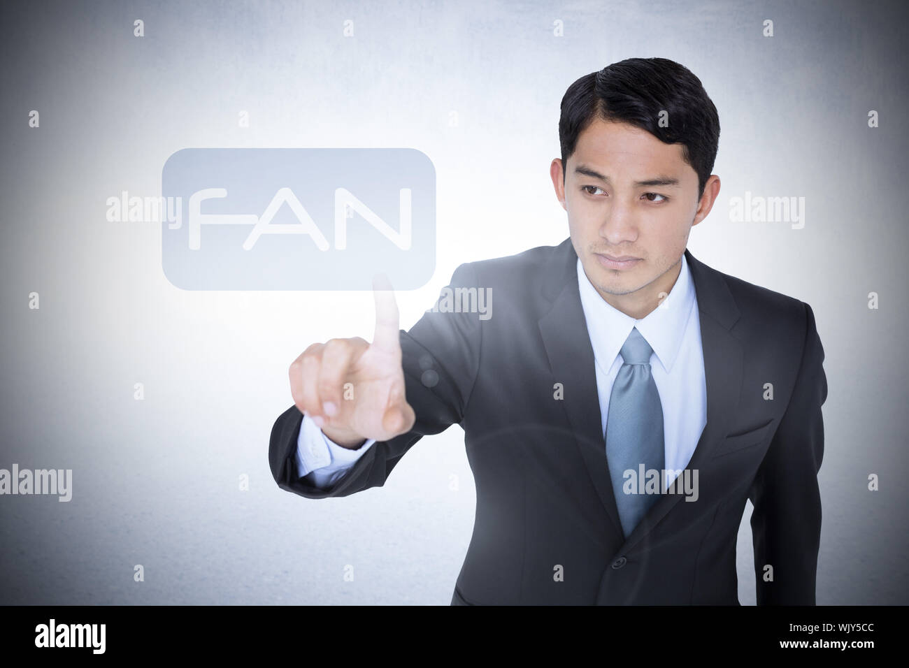 The word fan and unsmiling asian businessman pointing against white ...