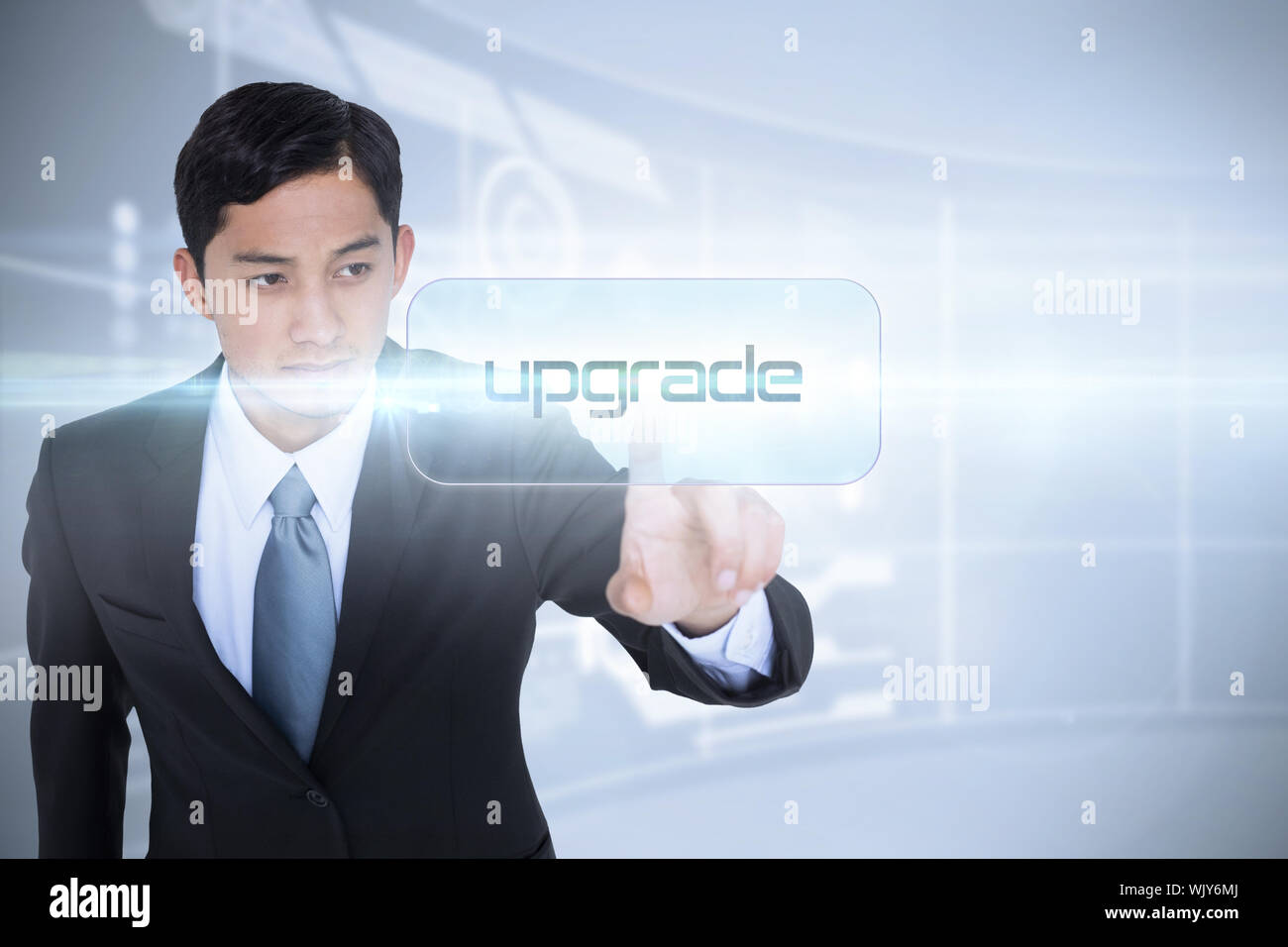 The word upgrade and unsmiling asian businessman pointing against ...