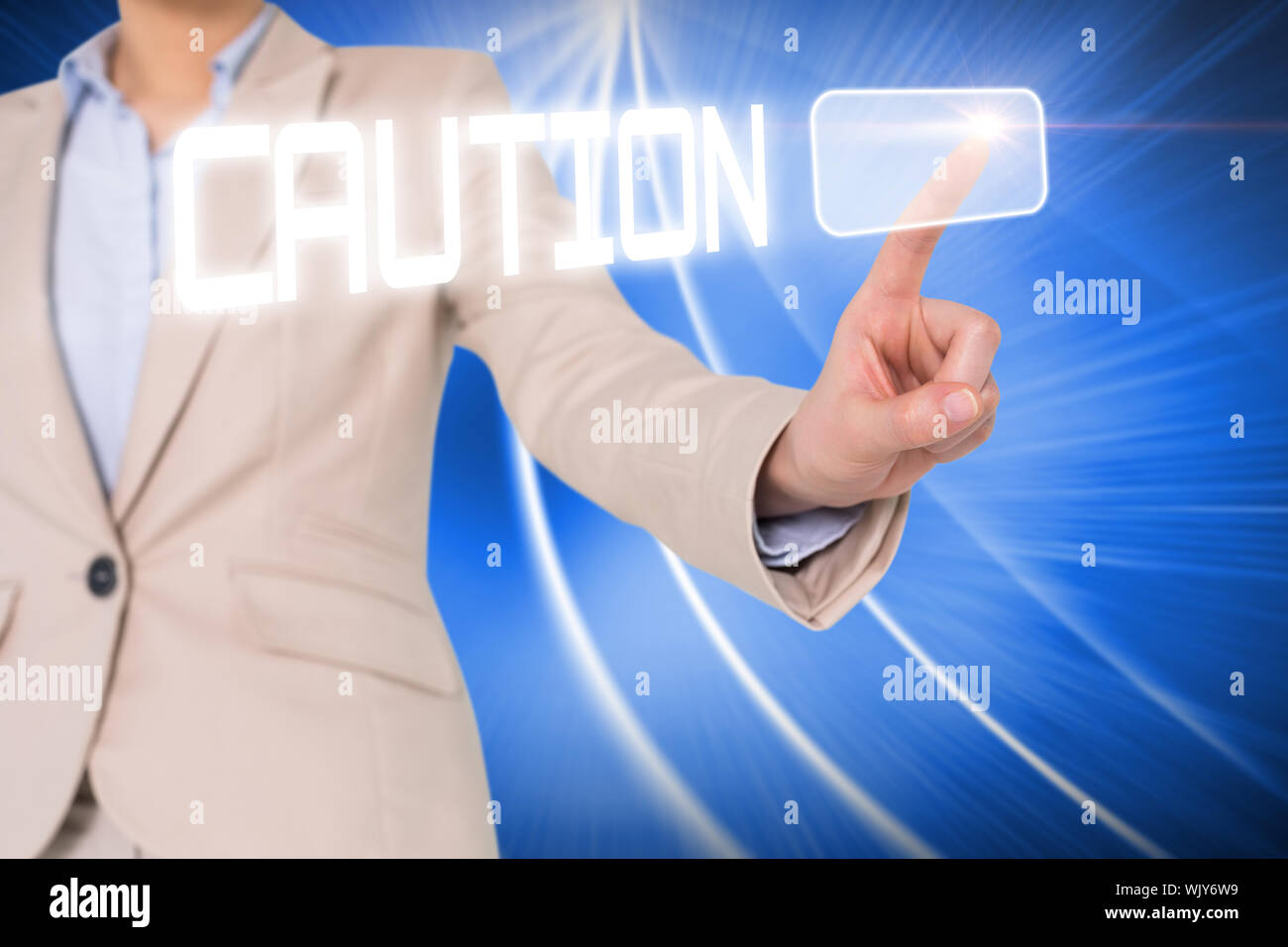 Businesswomans finger touching caution button against background with ...