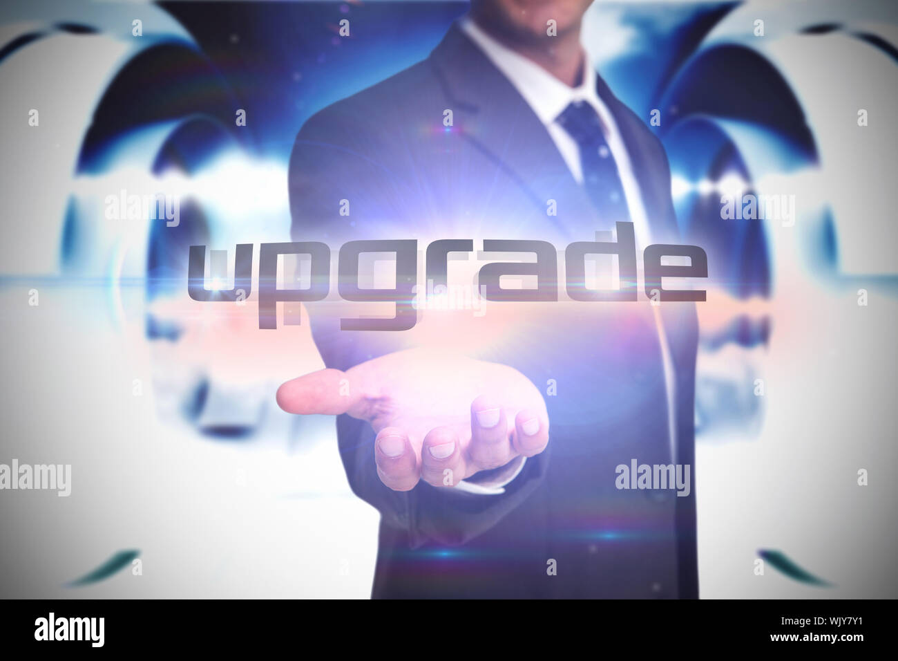 The word upgrade and businessman presenting against abstract cloud ...