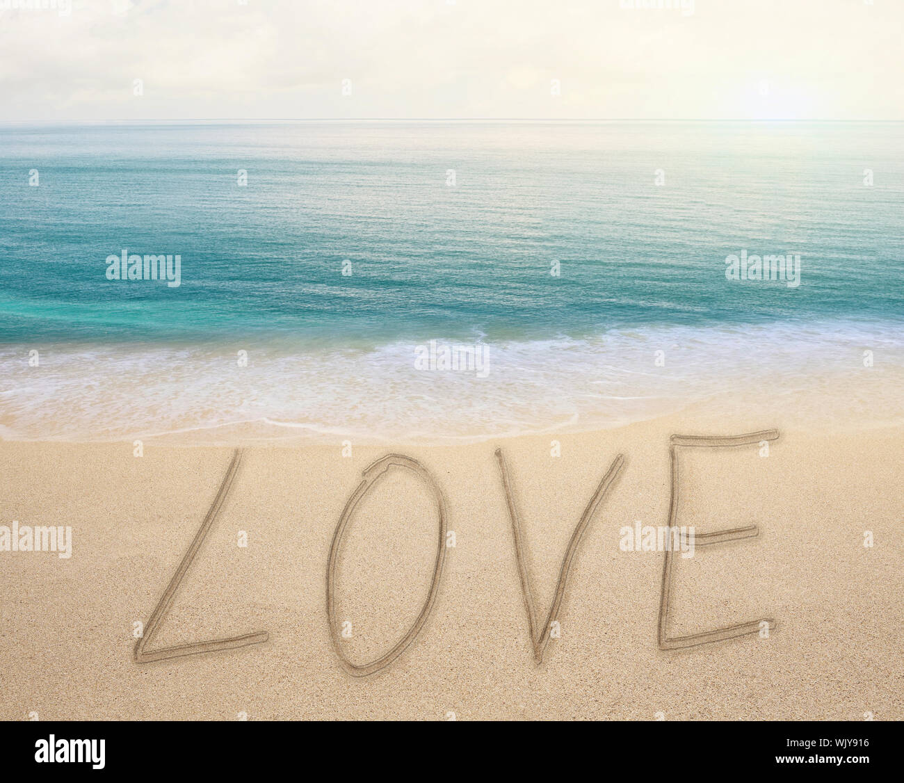 Landscape of beach with text on beach, love Stock Photo - Alamy