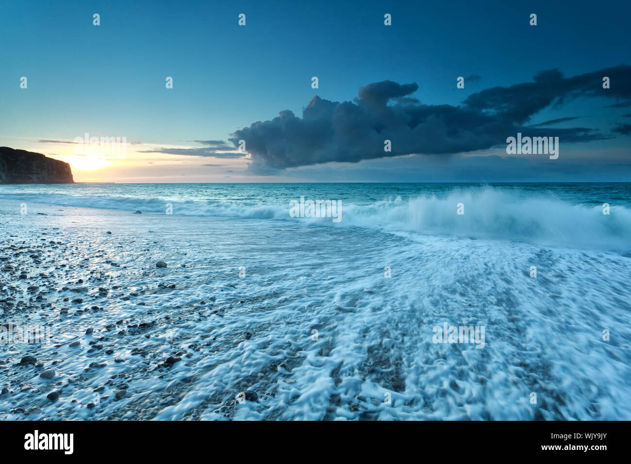 fresh ocean waves at sunset, Normandy, France Stock Photo - Alamy