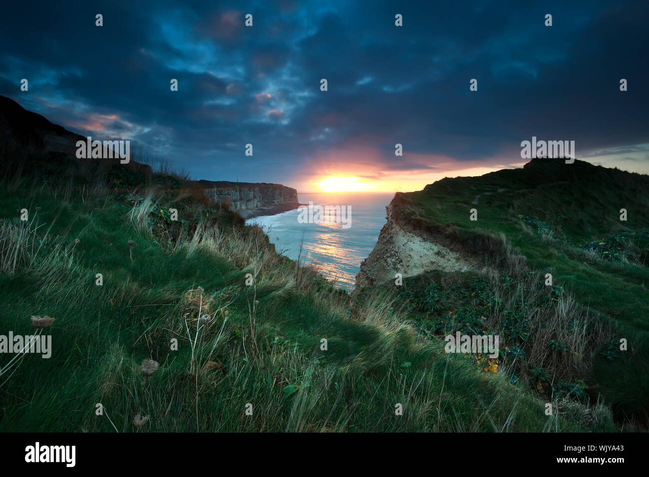 sunset over cliffs in ocean, Etretat, France Stock Photo - Alamy