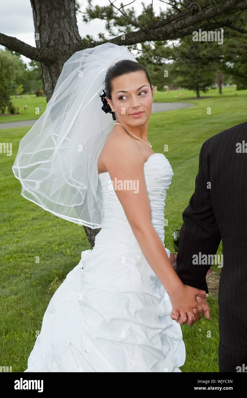 Just married bride looking behind her Stock Photo - Alamy