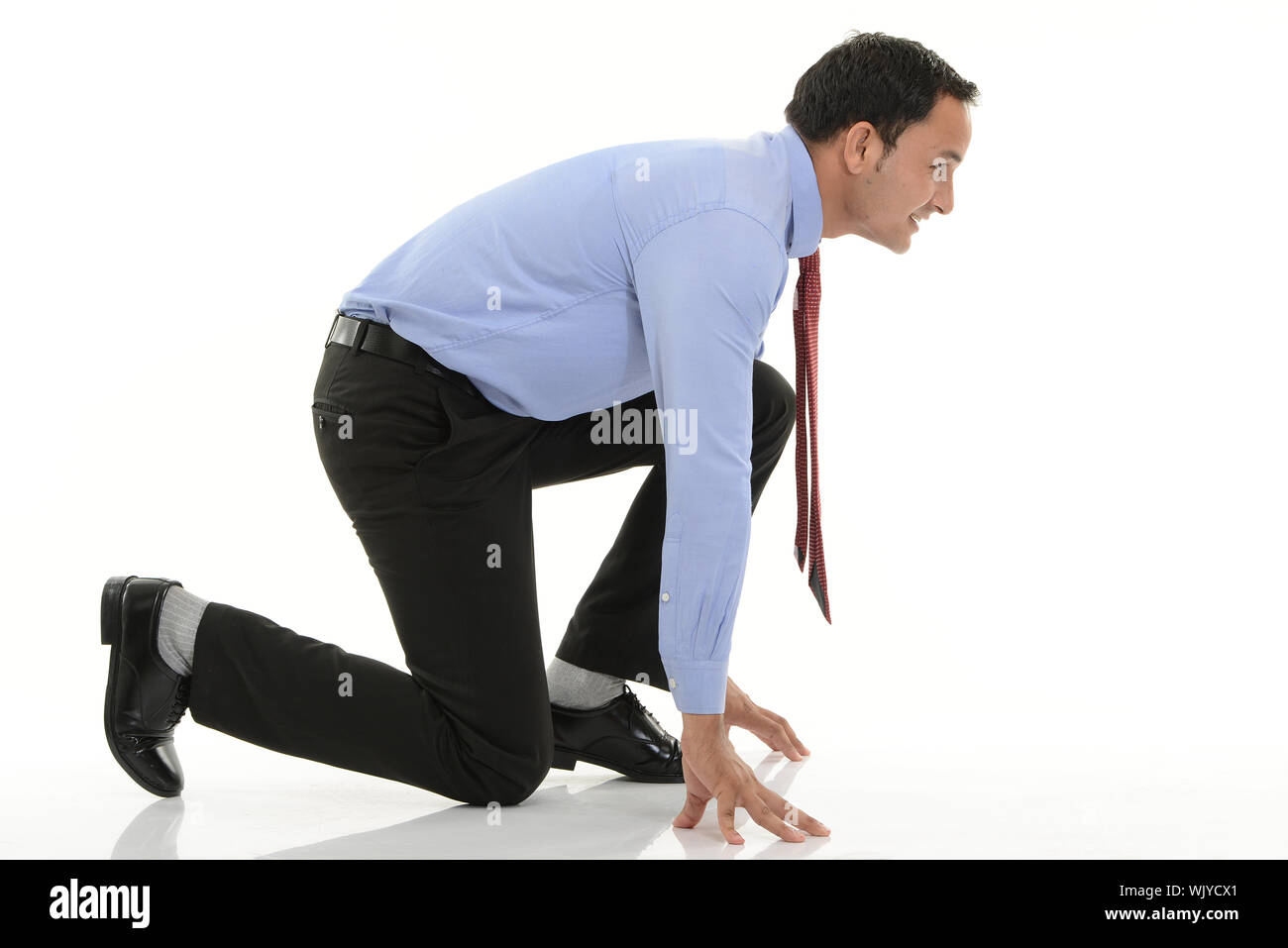 Businessman in race start position Stock Photo - Alamy