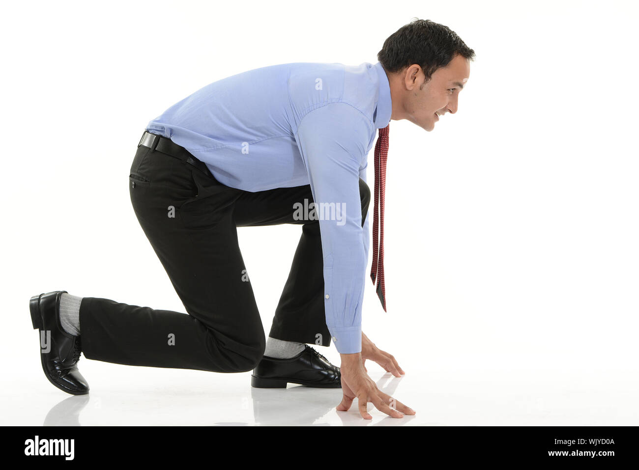 Businessman in race start position Stock Photo - Alamy