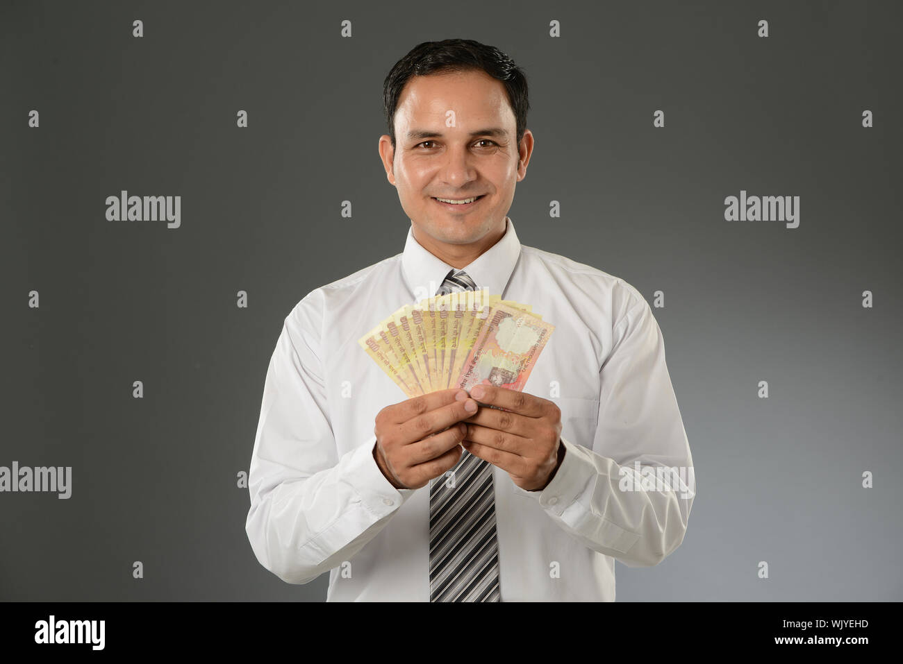 Indian businessman counting money hi-res stock photography and images ...