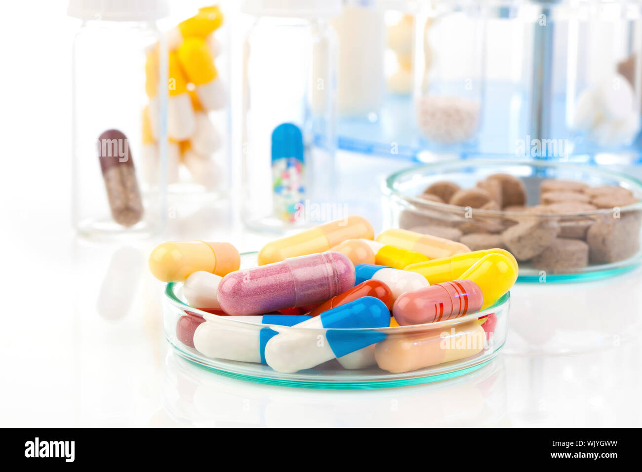 Colorful medical capsules in Petri dishes. Laboratory concept Stock ...