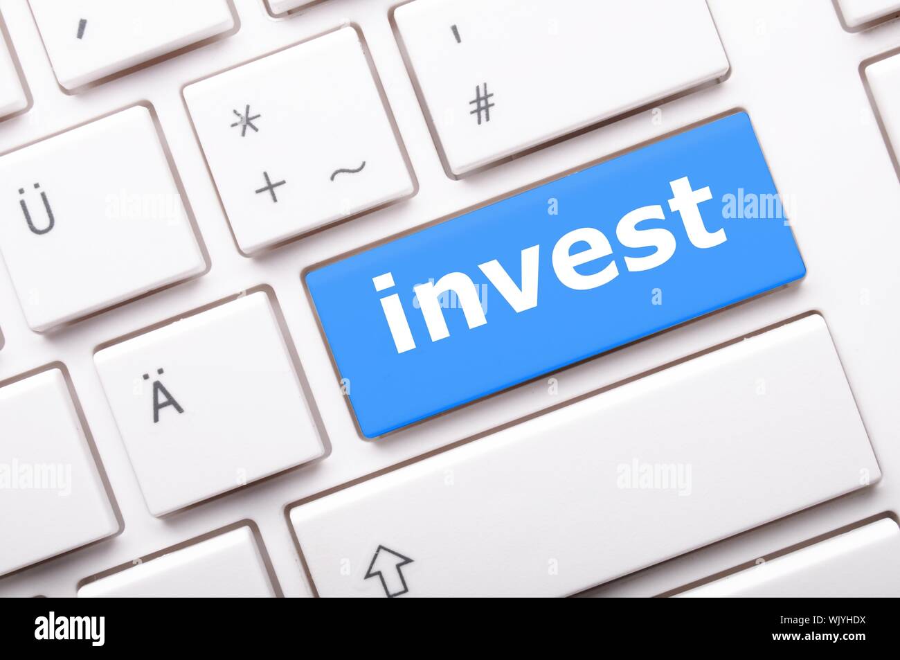 invest key on keyboard showing financial business investment concept ...