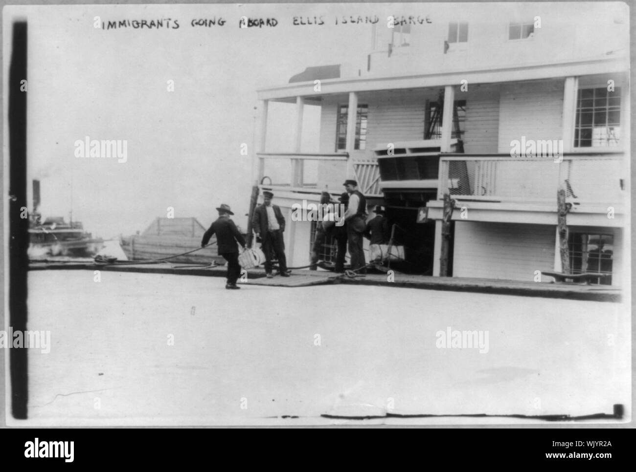 Immigrants going aboard Ellis Island barge Stock Photo - Alamy