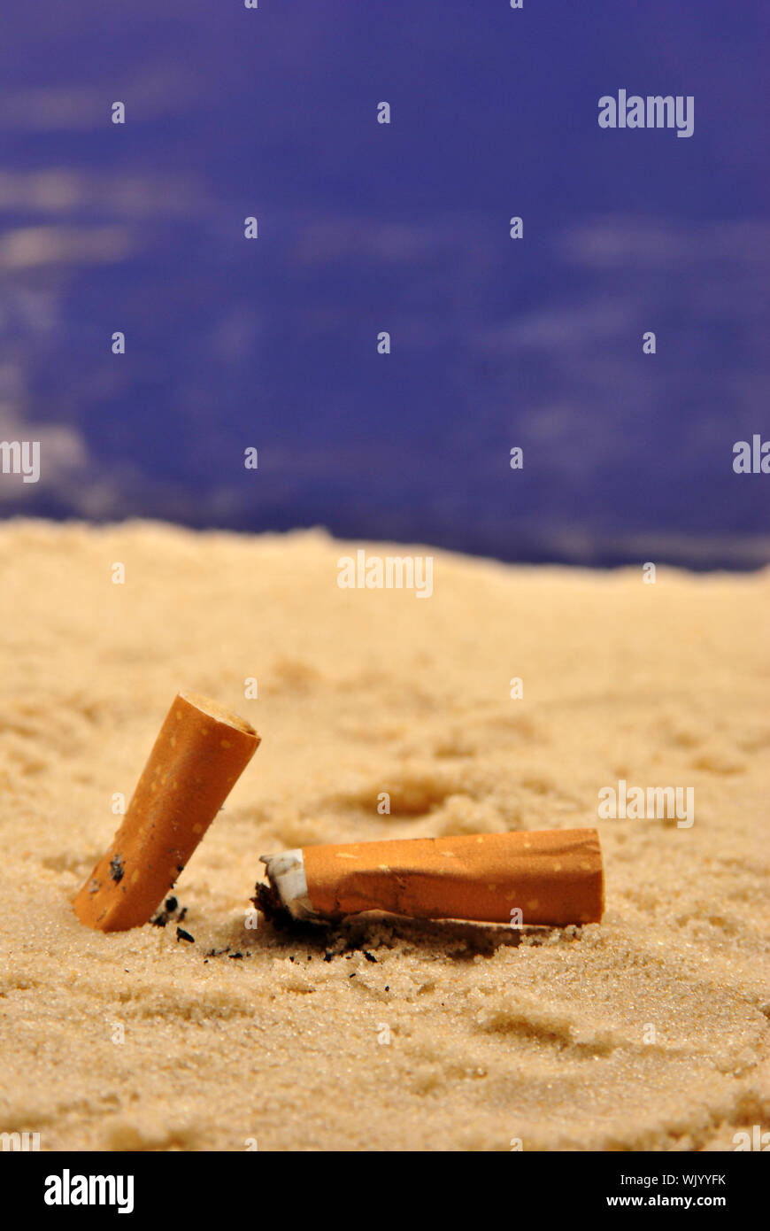 some cigarette ends on a sandy beach Stock Photo - Alamy
