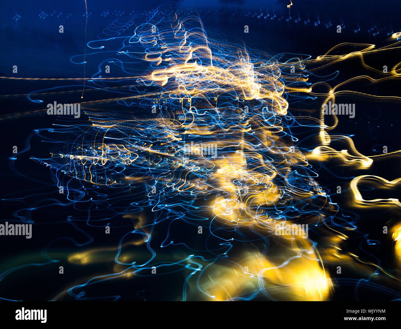 Color lights passing over water surface Stock Photo - Alamy