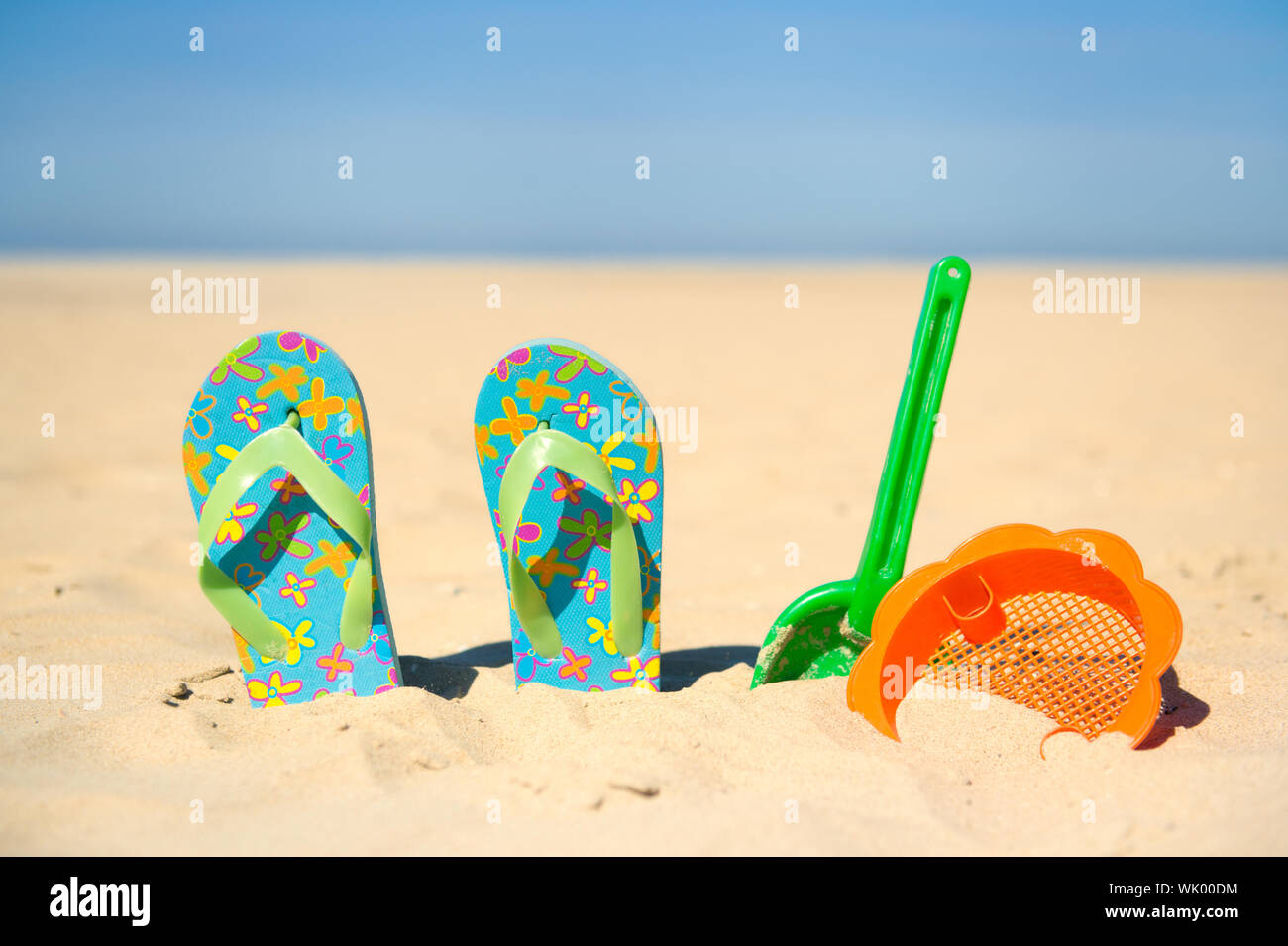 Flip flops and toys at the beach Stock Photo - Alamy