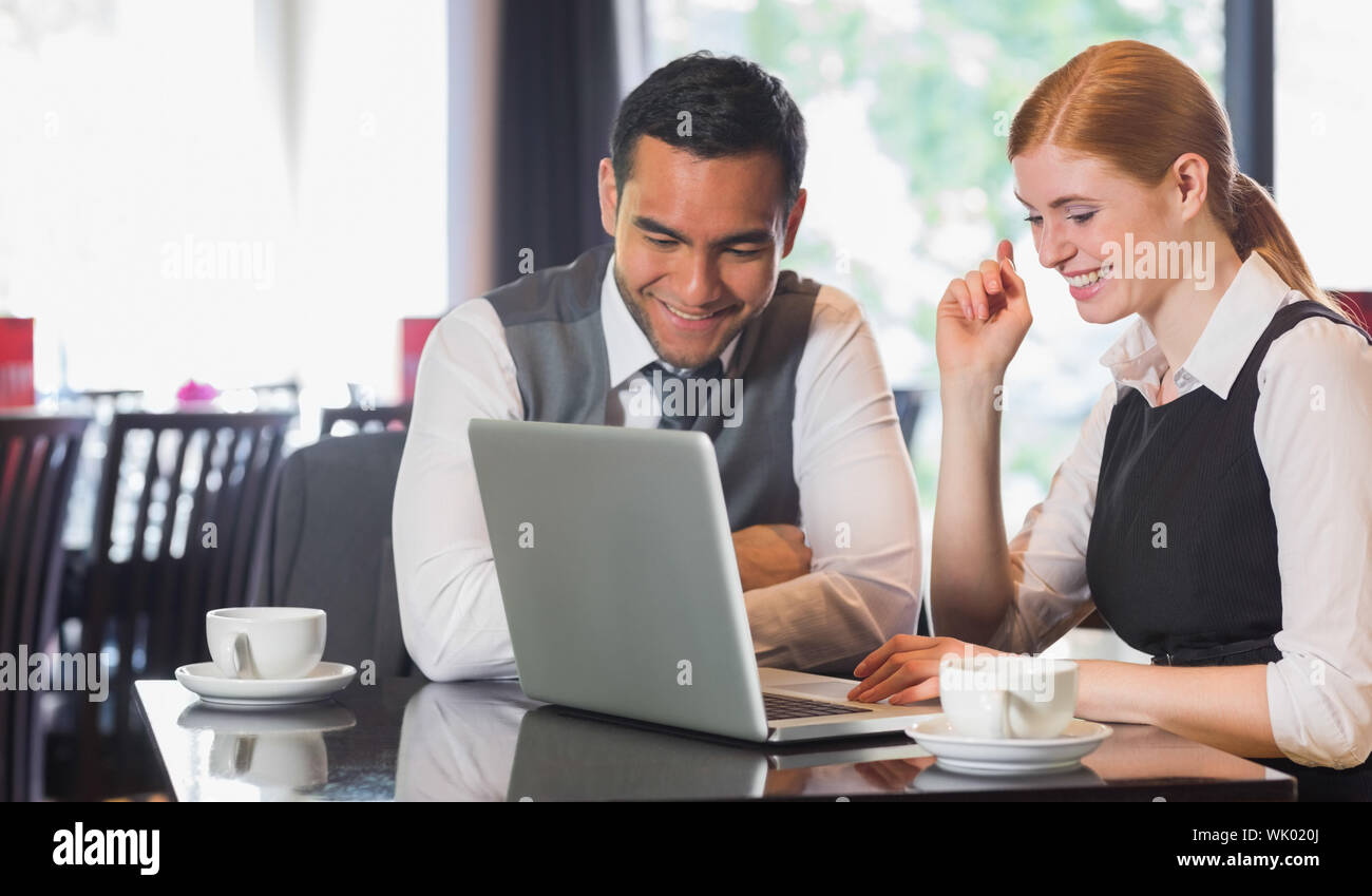 Happy business team working together in a cafe Stock Photo - Alamy