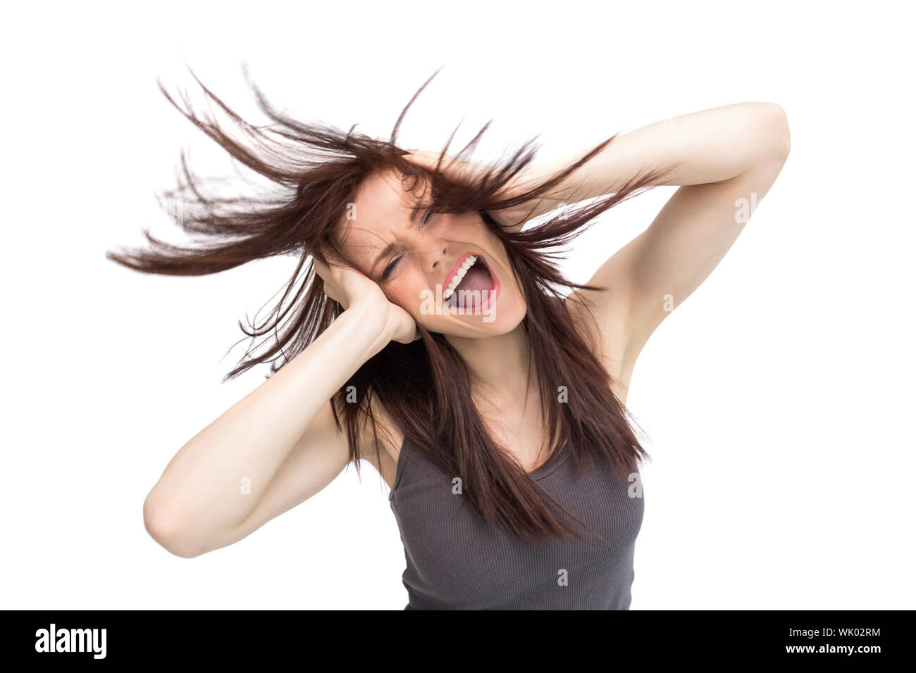 Furious pretty brunette tossing her hair Stock Photo - Alamy