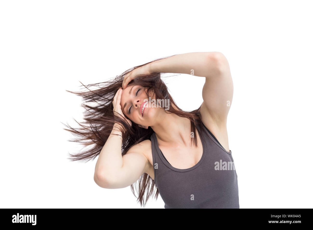 Pretty young brunette tossing her hair Stock Photo - Alamy