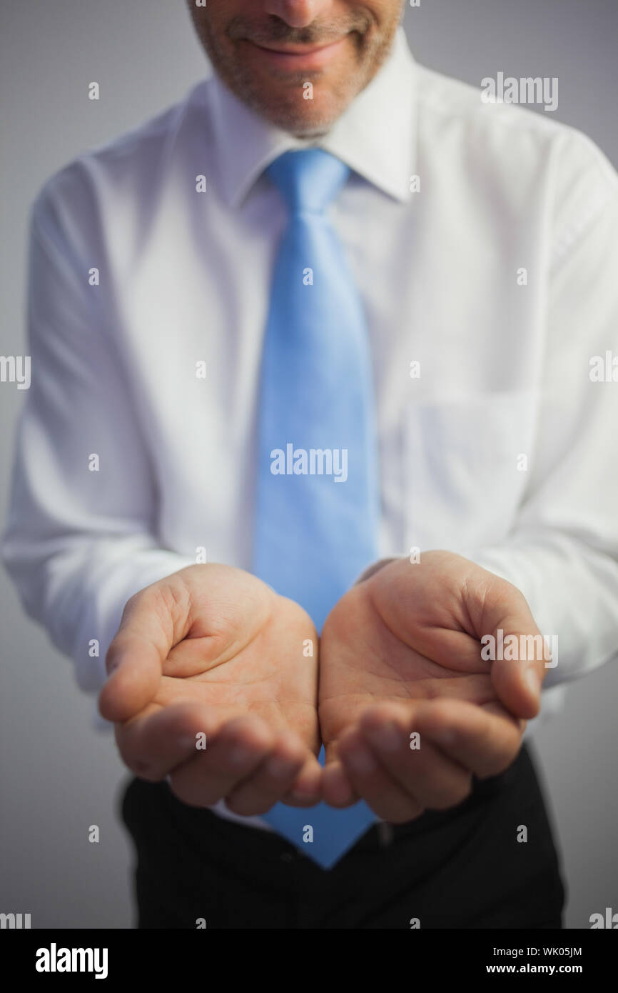 Close up of a smiling businessman joining his hands to the camera Stock ...